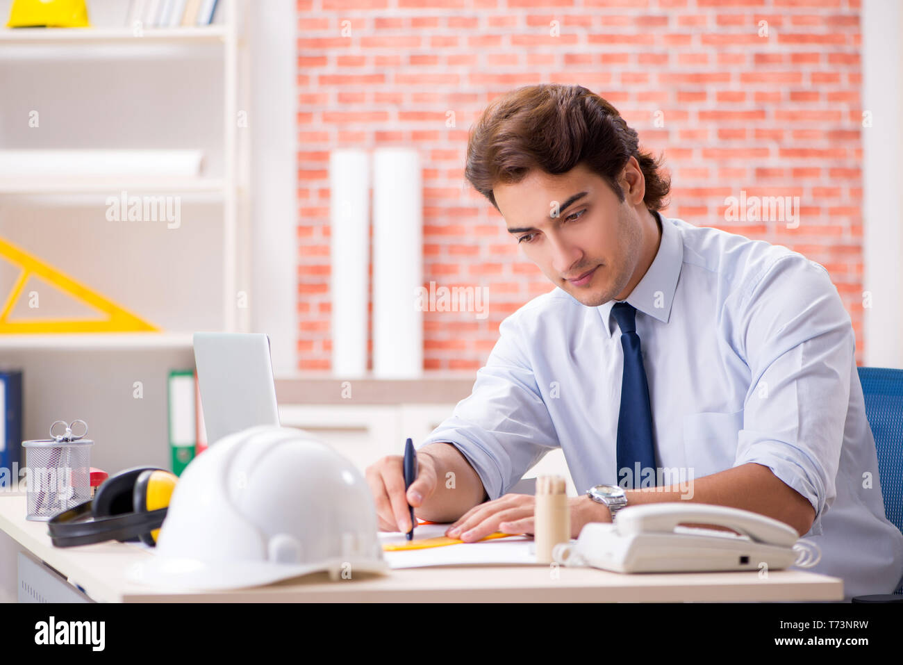 Construction supervisor working on blueprints Stock Photo - Alamy