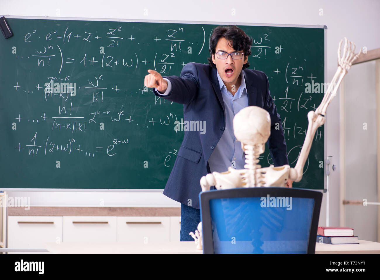 Young male math teacher and student skeleton Stock Photo - Alamy