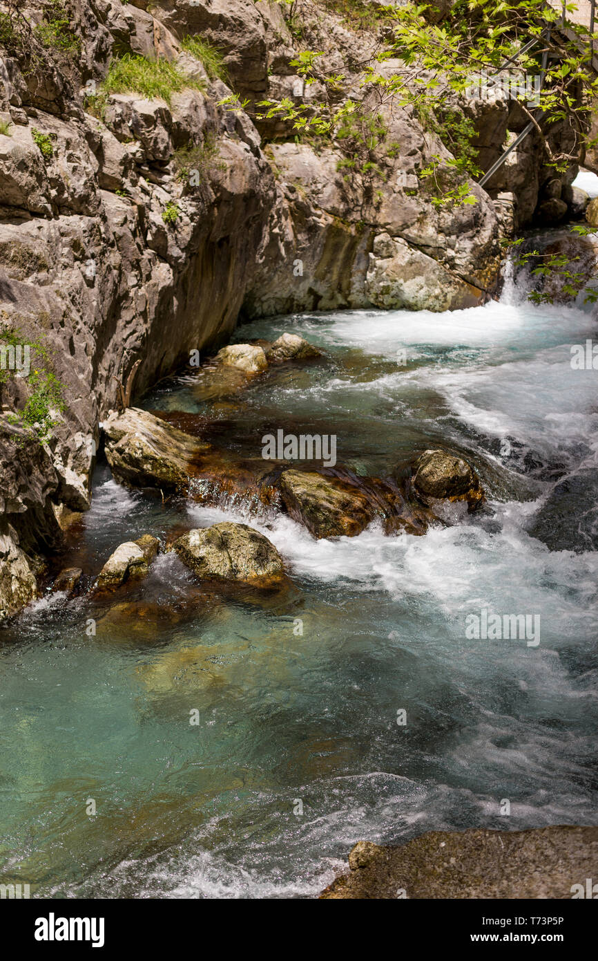 Vertical shot of a powerful water stream in the mountain river canyon ...