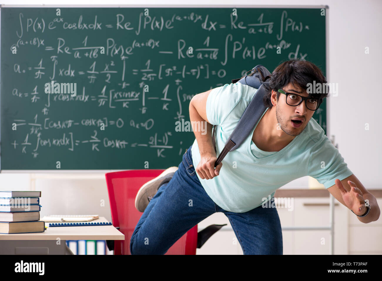 Young male student mathematician in front of chalkboard Stock Photo - Alamy