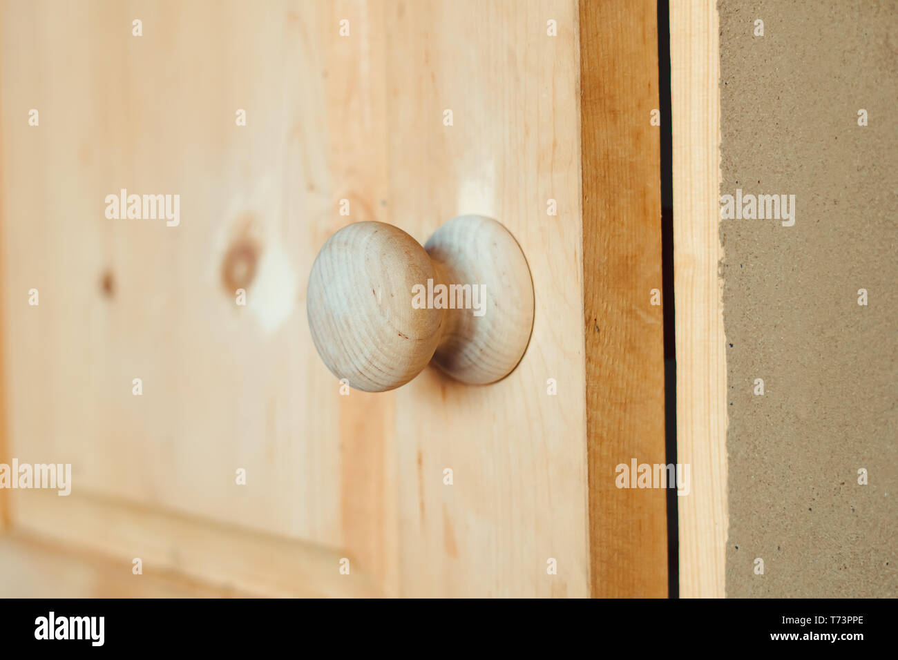 round wooden handle on a white wooden door Stock Photo - Alamy