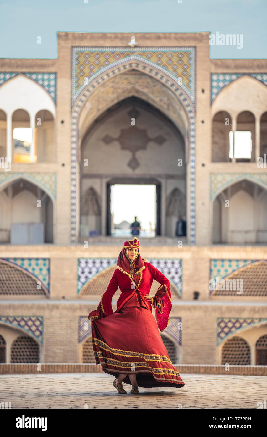young beautiful iranian lady dressed in red traditional dress in a ...