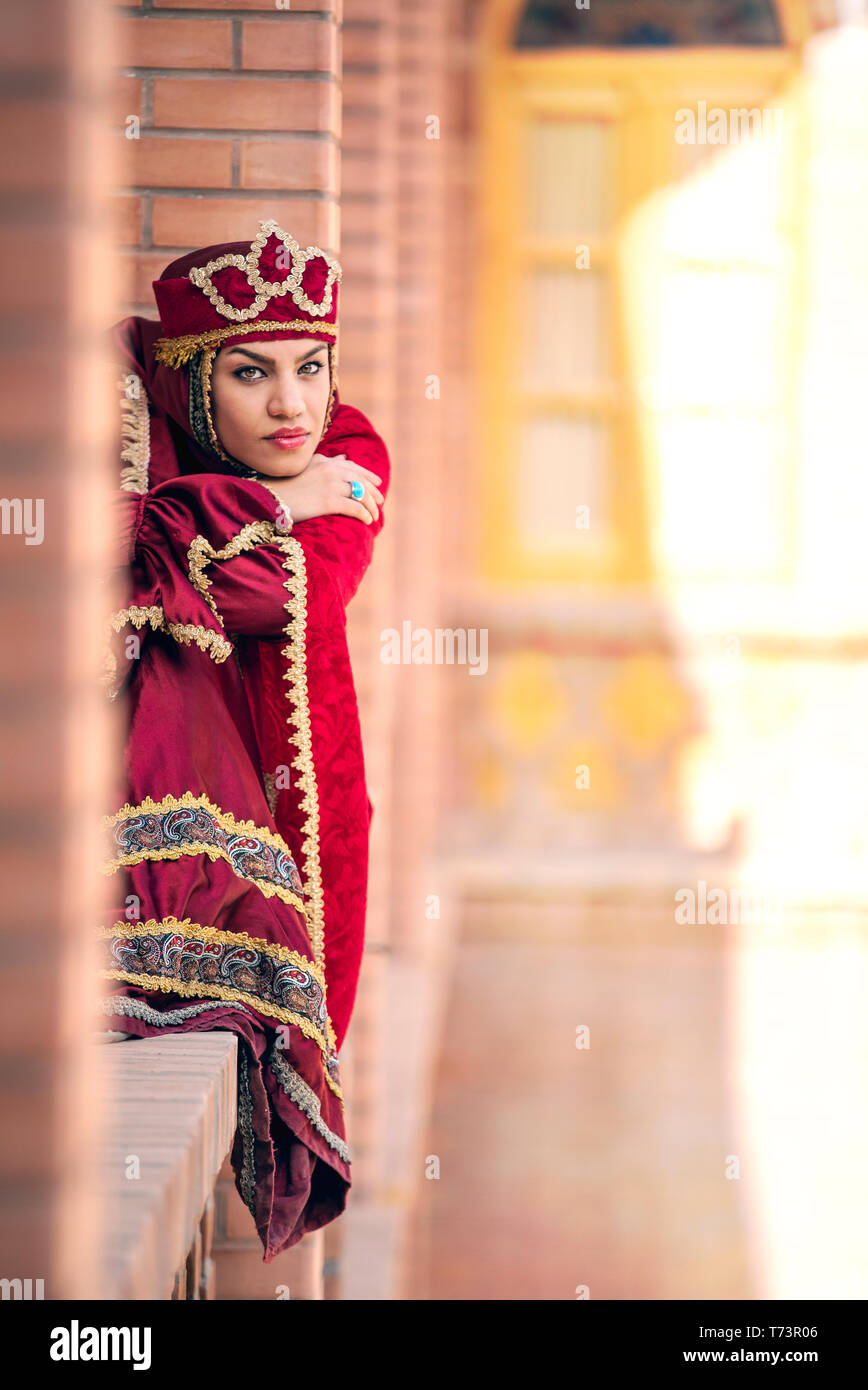 Iranian woman in red traditional dress Stock Photo - Alamy