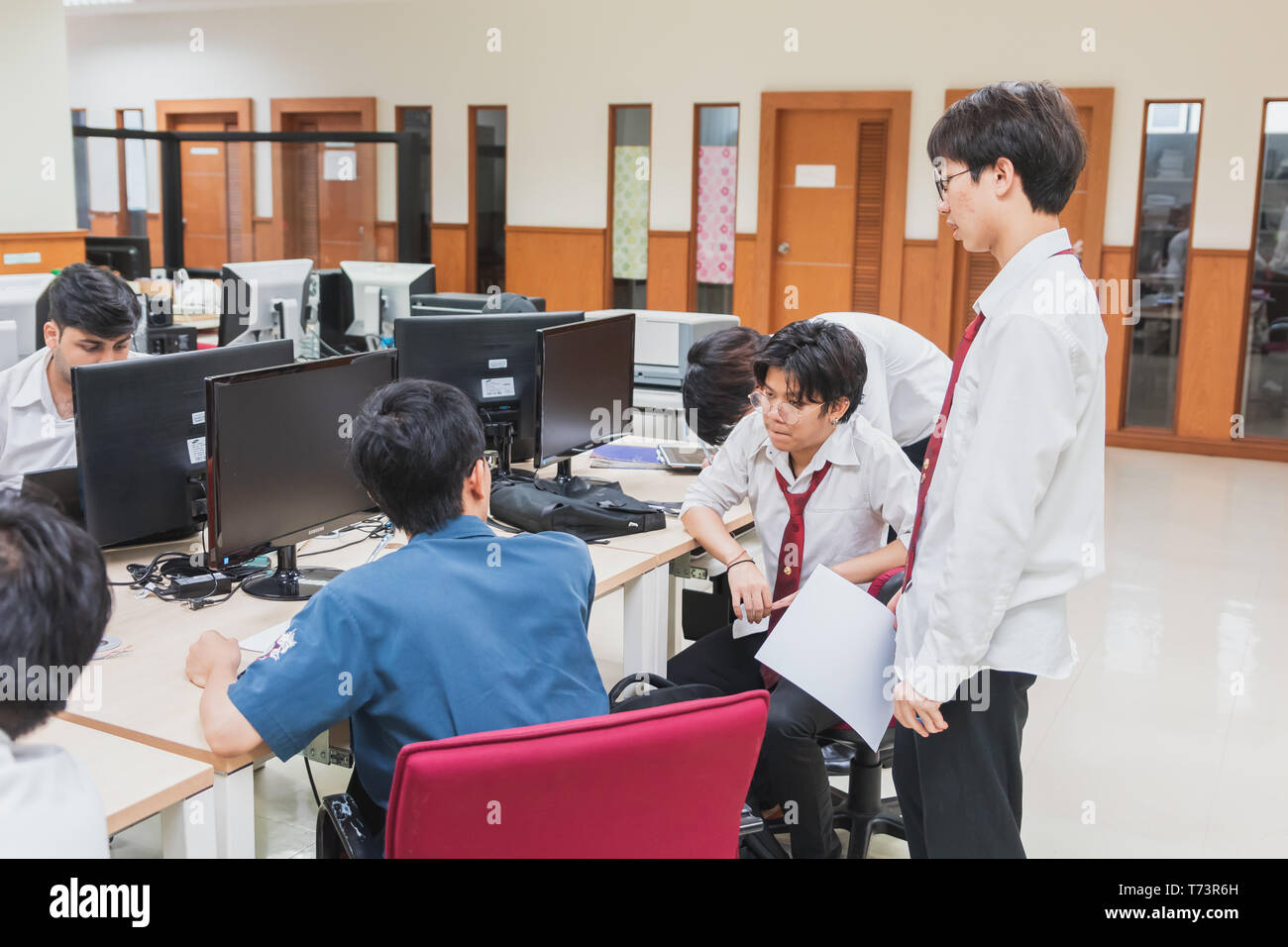Group of Thai University Students discussing about their final computer ...