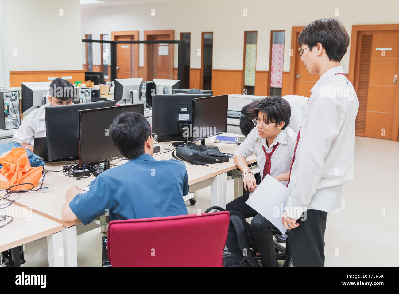 Group of Thai University Students discussing about their final computer ...