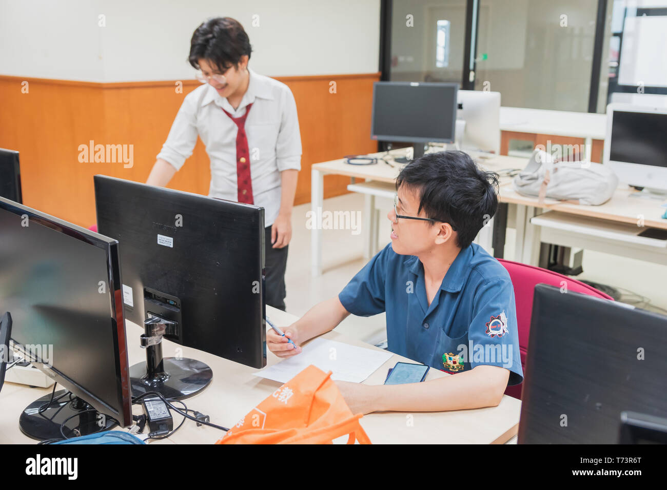 Group of Thai University Students discussing about their final computer ...