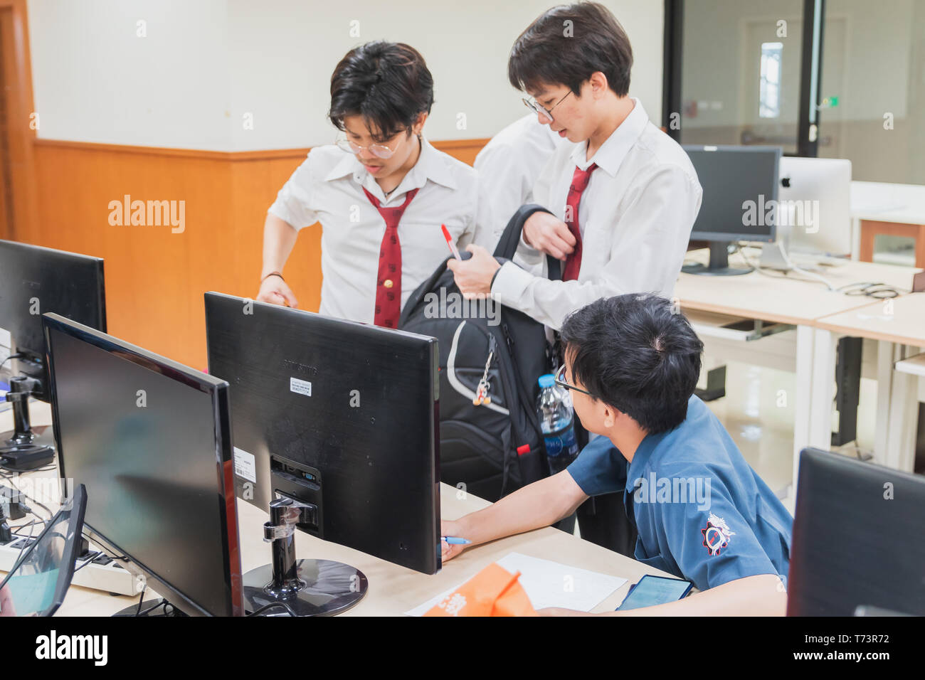 Group of Thai University Students discussing about their final computer ...
