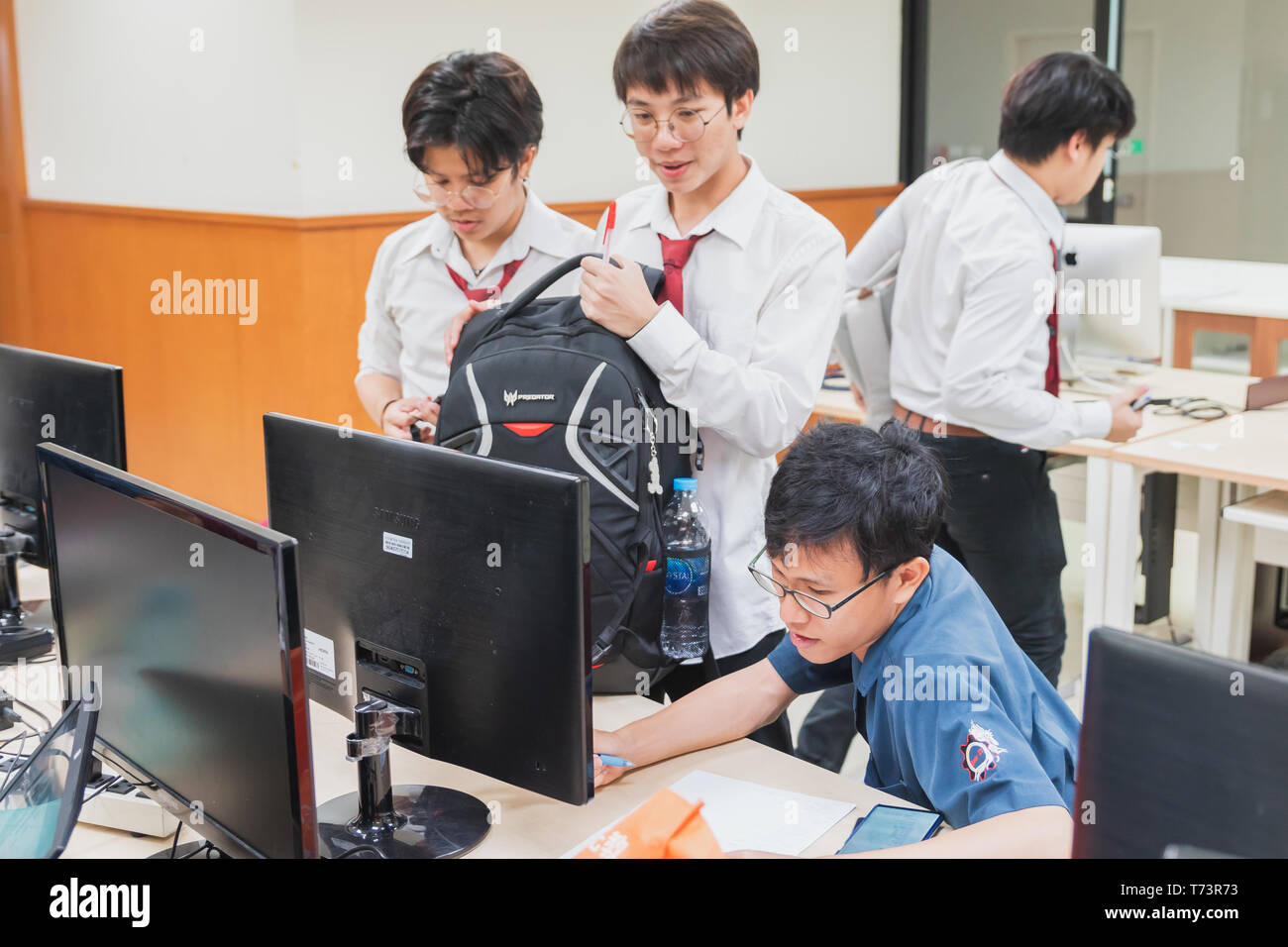 Group of Thai University Students discussing about their final computer ...