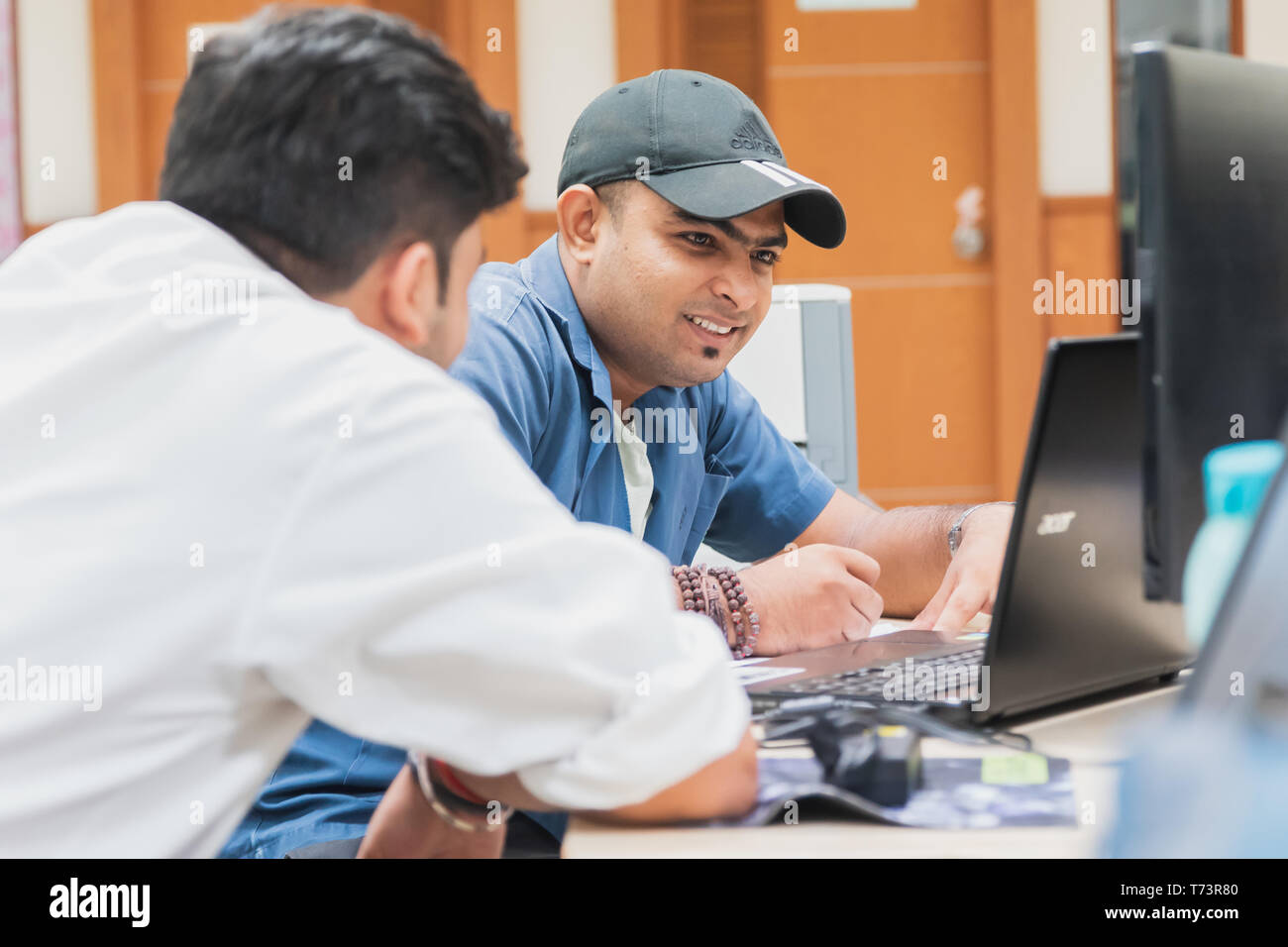 Two asian university student discuss about their assignment in a ...