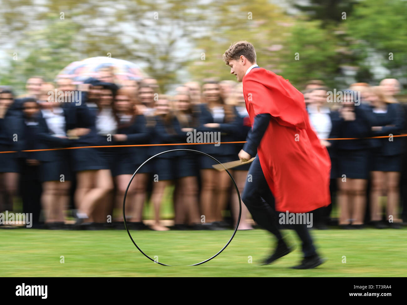 Pupils take part in the annual King's Ely Hoop Trundle on the east lawn ...