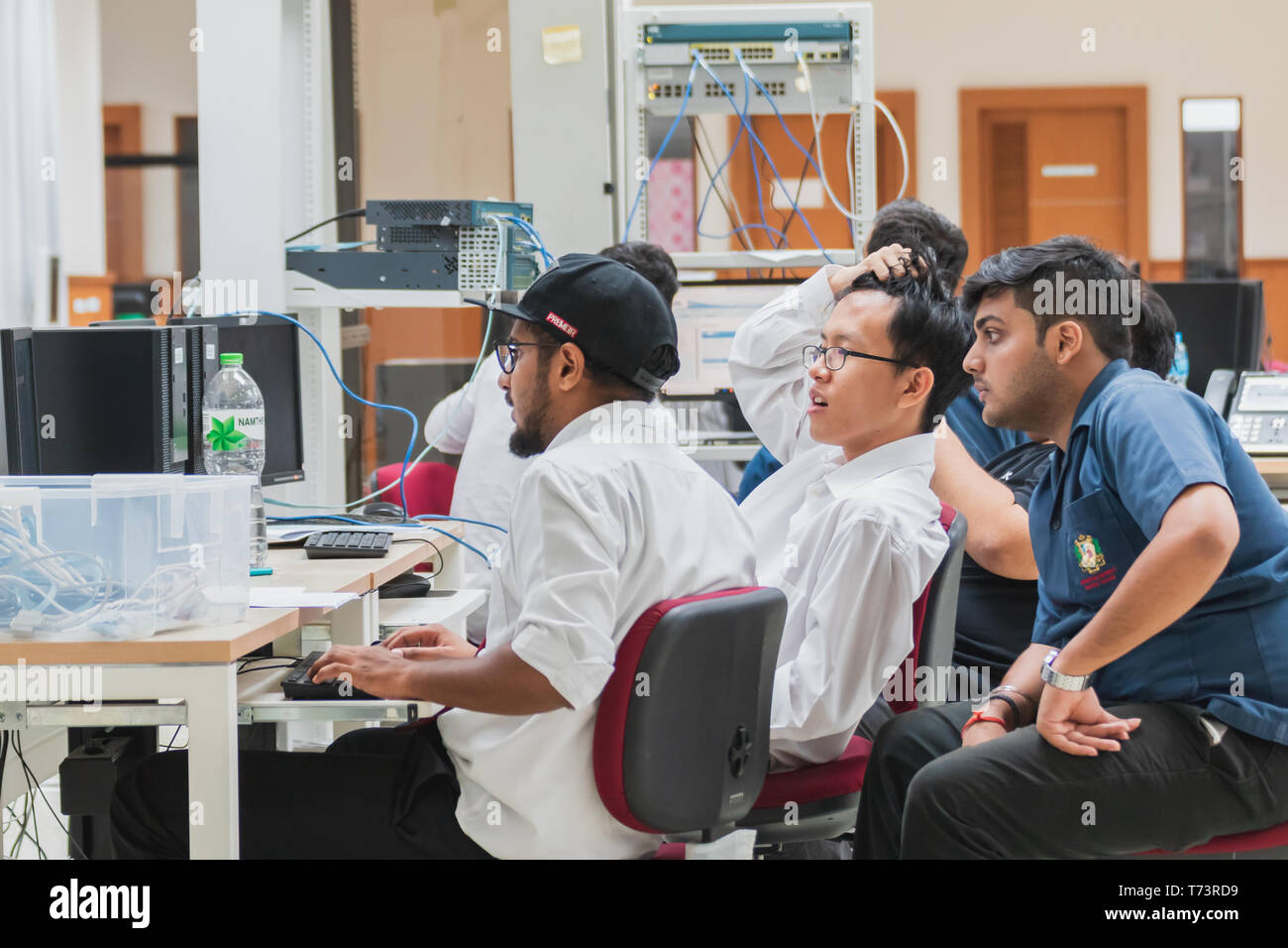 Group of Asian university computer engineering students working and ...