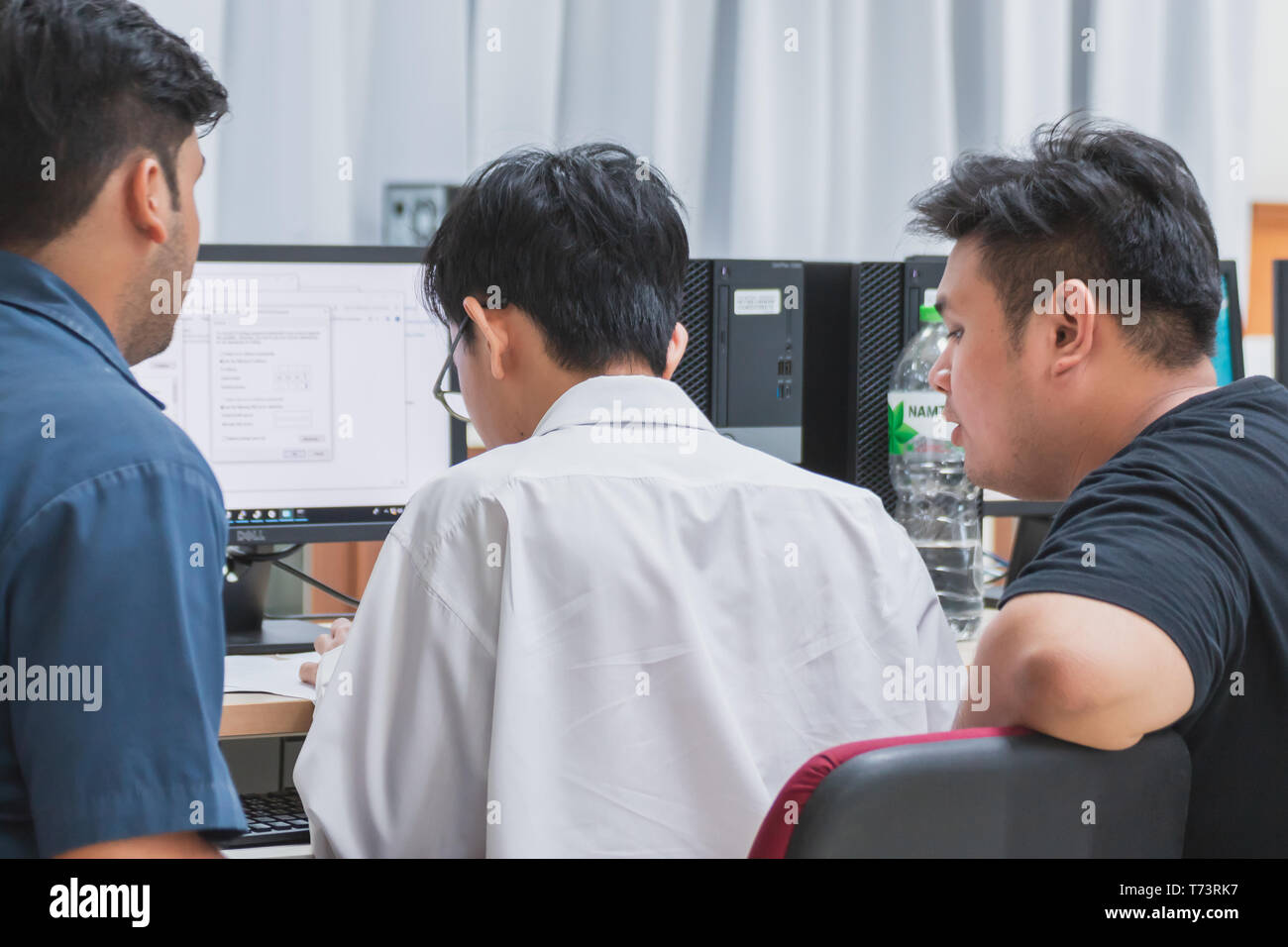 Group of Asian university computer engineering students working and ...