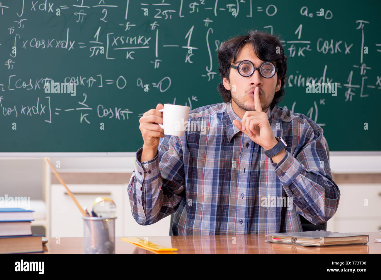 Funny male math teacher in the classroom Stock Photo - Alamy