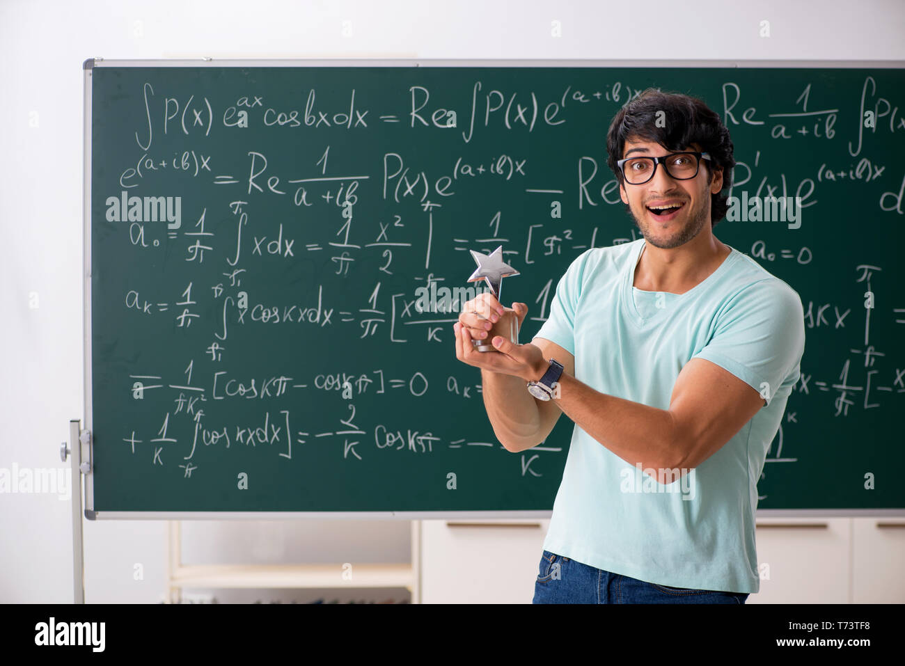 Young male student mathematician in front of chalkboard Stock Photo - Alamy