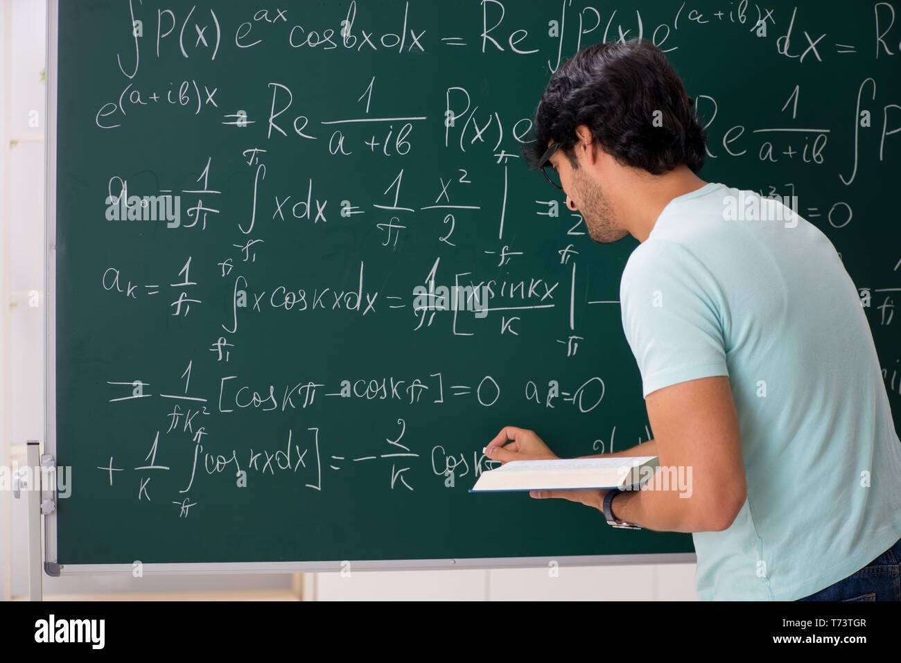 Young male student mathematician in front of chalkboard Stock Photo - Alamy