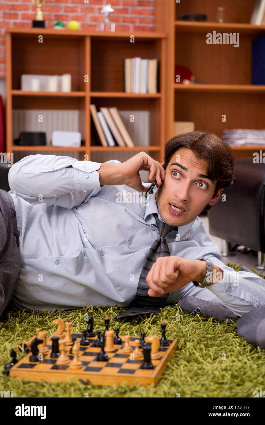 Young handsome boss playing chess during break Stock Photo - Alamy