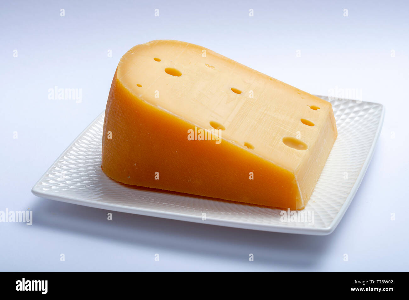 One piece of traditional Dutch old hard cheese made from cow milk close ...