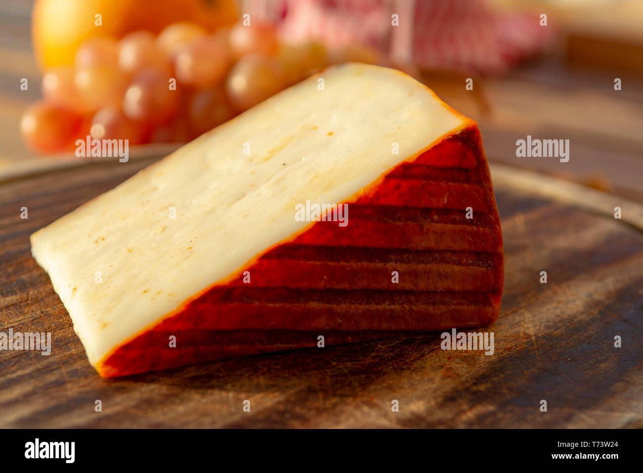 Spanish goat milk cheese with paprika coating and ripe pink table ...
