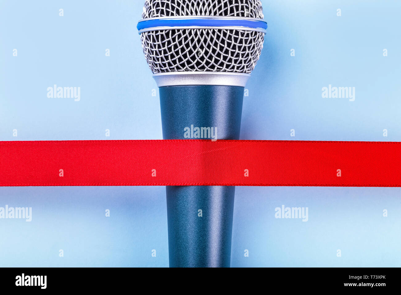 Microphone with red tape over blue background, music concept Stock ...