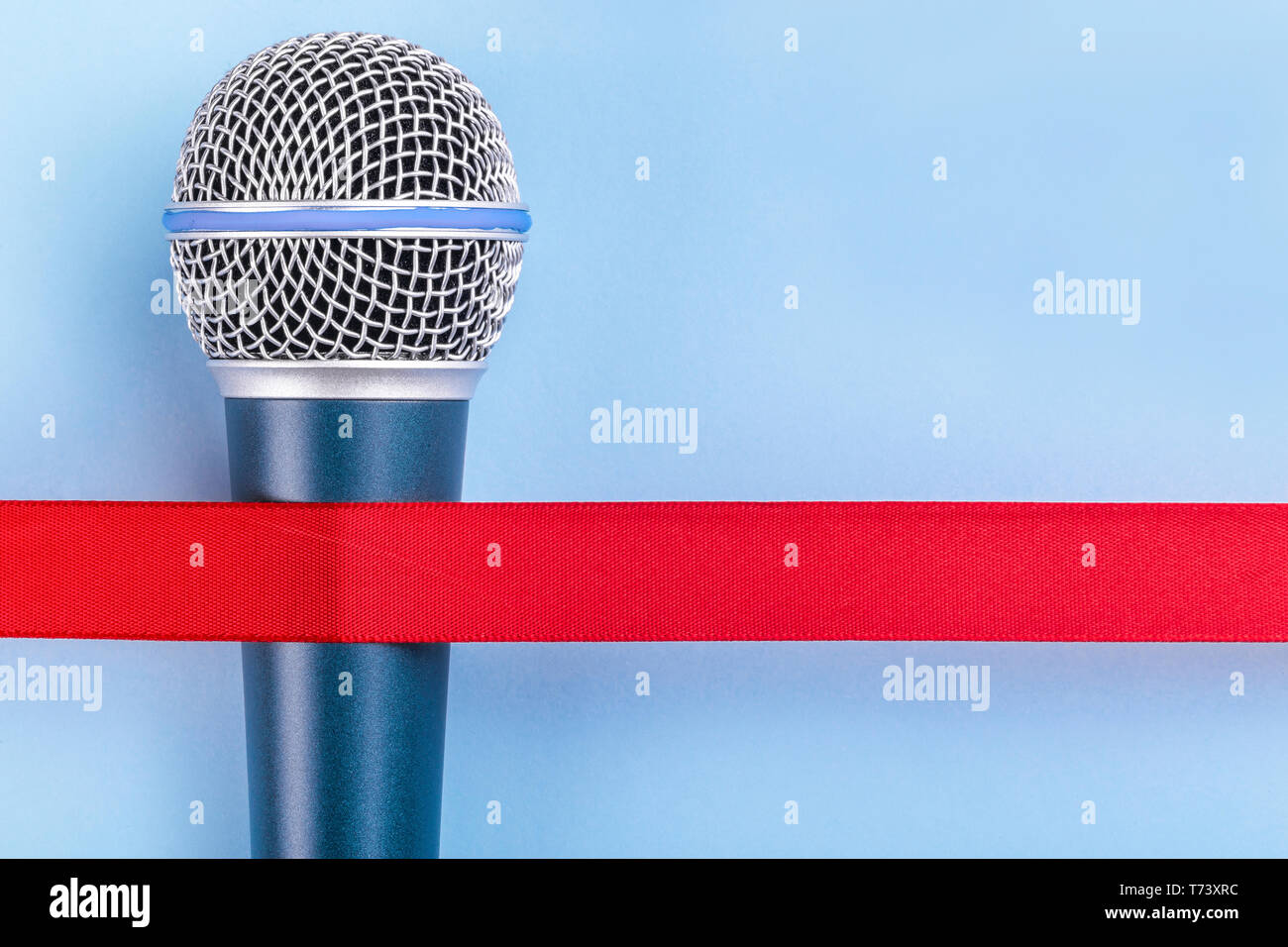 Microphone with red tape over blue background, music concept Stock ...