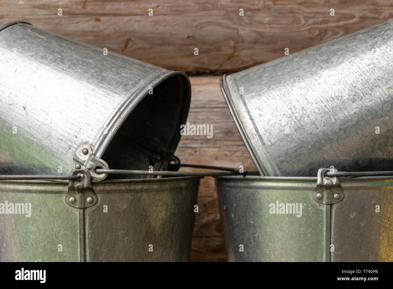 Stack of vintage metal buckets on a market stall, with enamel paint and ...