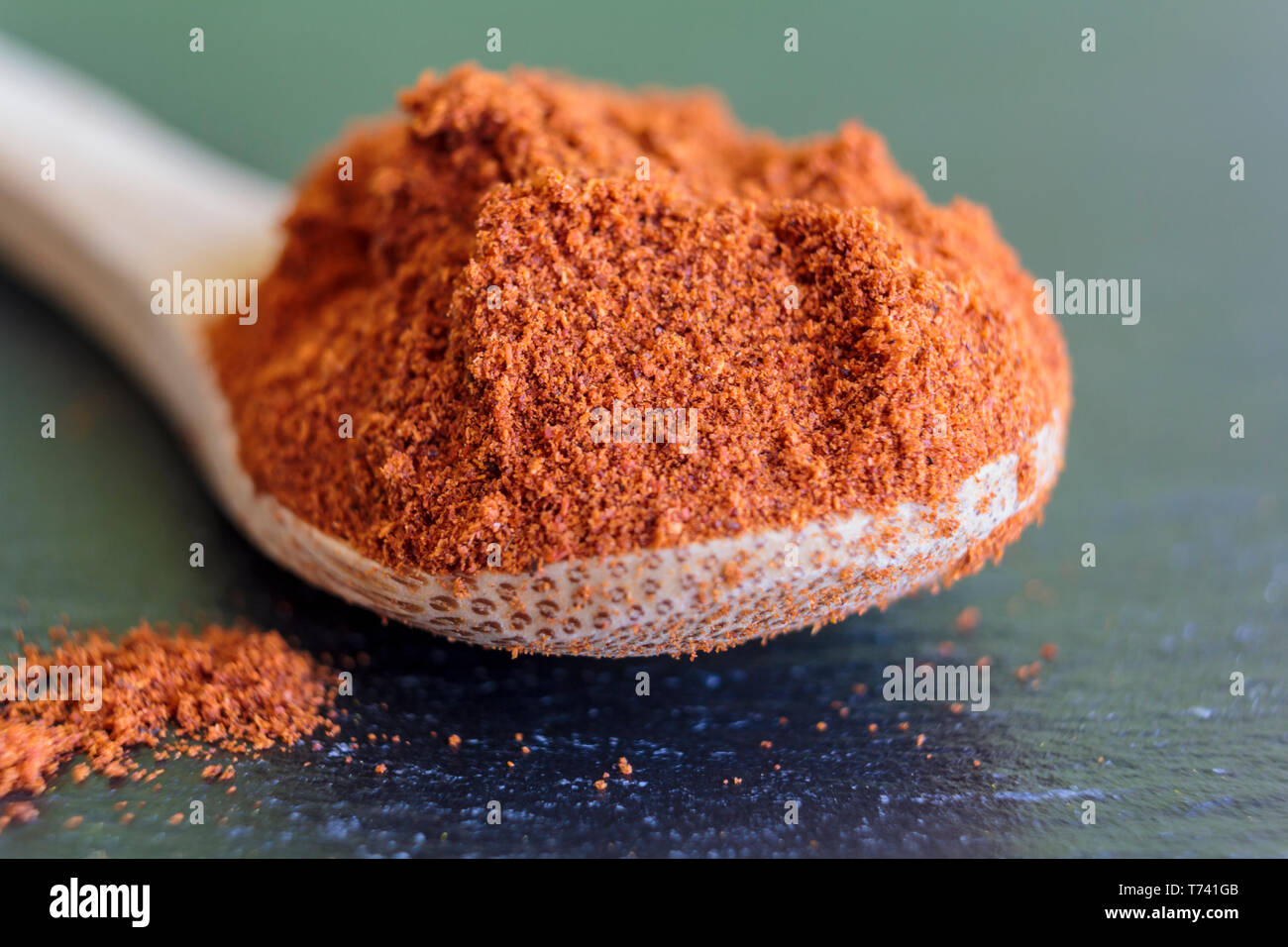 Wooden spoon with cayenne pepper, red chilli powder Stock Photo - Alamy