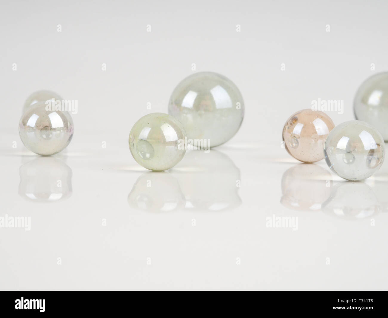 Glass marbles on a grey surface. beautiful reflection, abstract ...