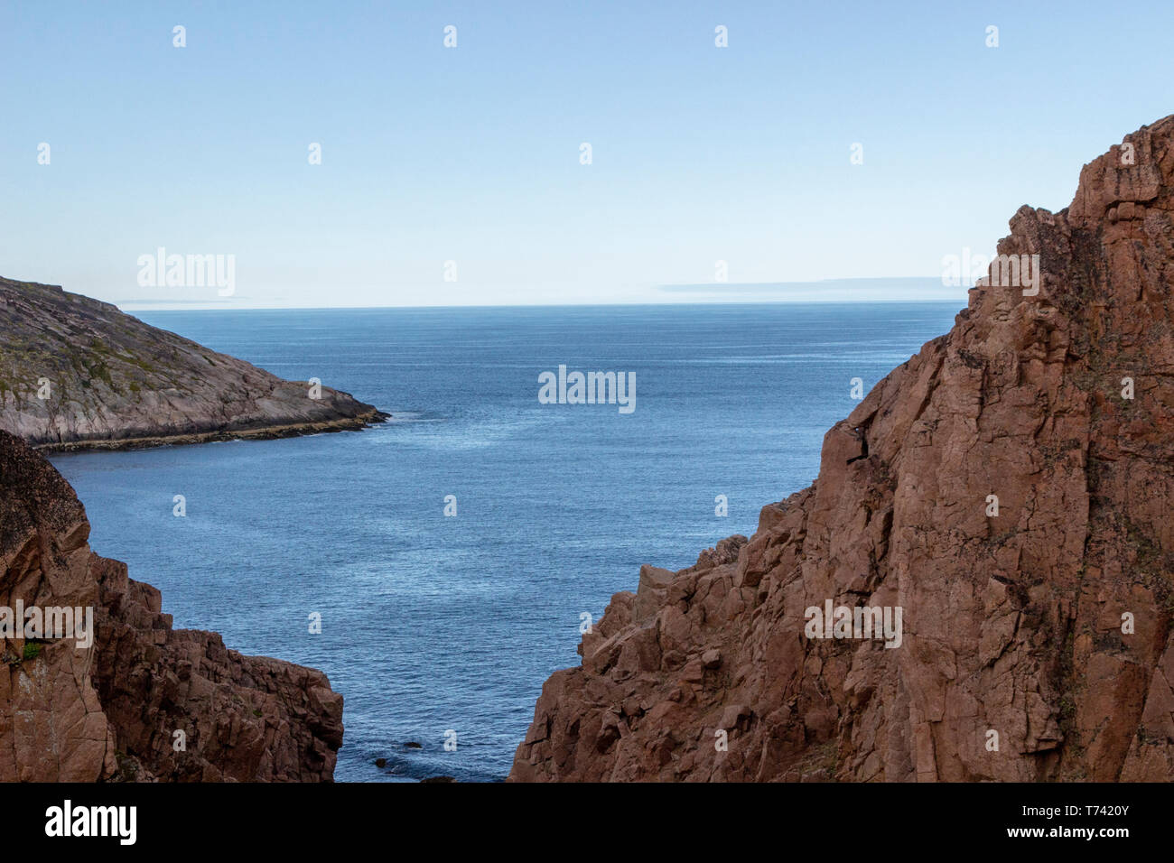 river meets ocean along a rocky shoreline with heavy water flow in a ...