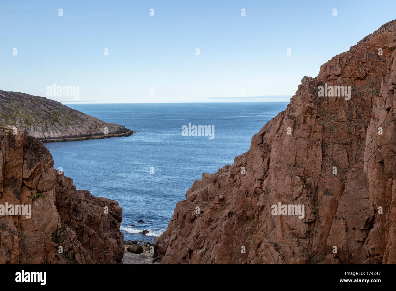 river meets ocean along a rocky shoreline with heavy water flow in a ...