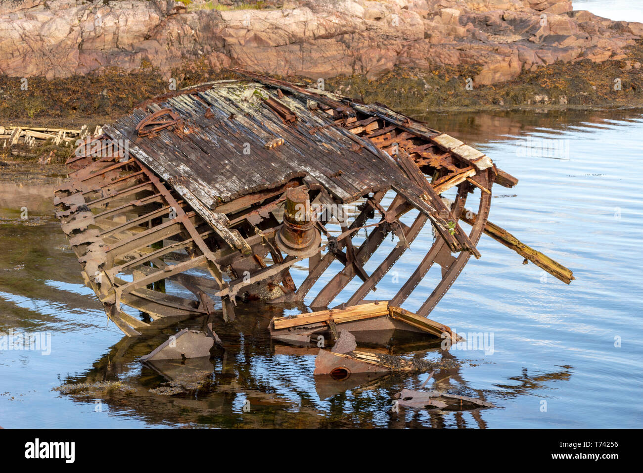 old shipwreck or abandoned shipwreck, broken fishing ship lies on its ...