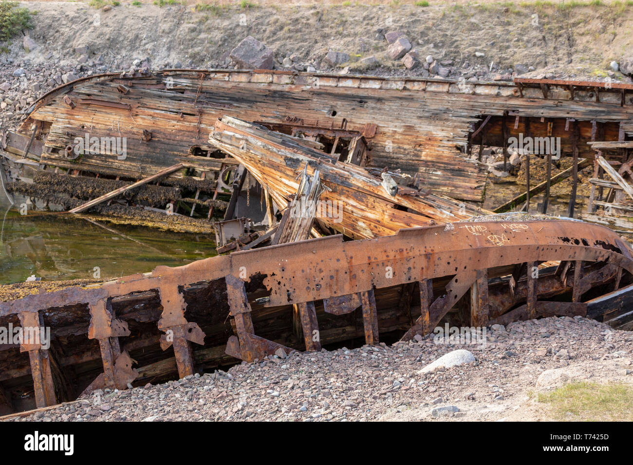 old shipwreck or abandoned shipwreck, broken fishing ship lies on its ...