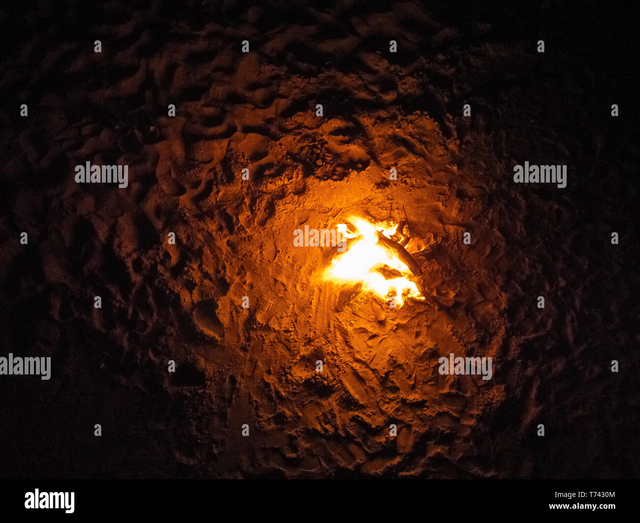 Bonfire on sand above top view at night time Stock Photo - Alamy