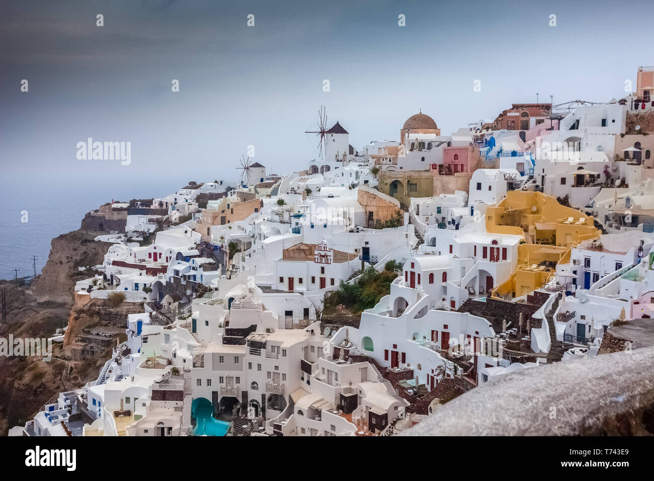 View of colorful and pictoresque village of Oia on a rare rainy day ...