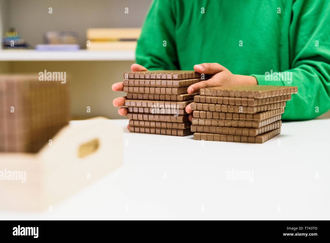 Child placing some blocks to count numbers is his house, concept of ...