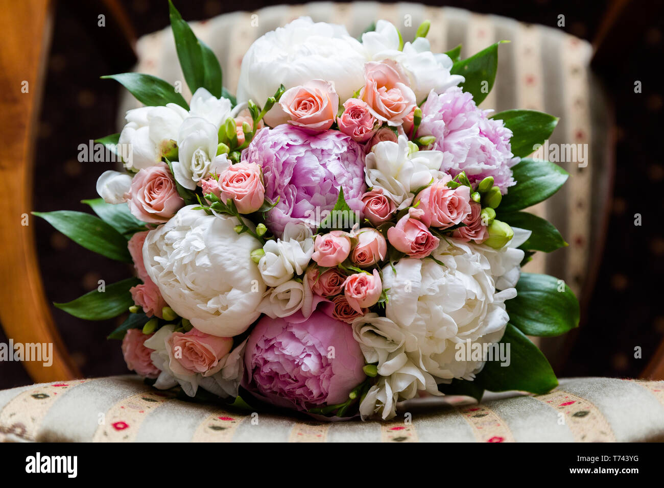Beautiful bouquet of peonies, pink roses and freesias, against the ...