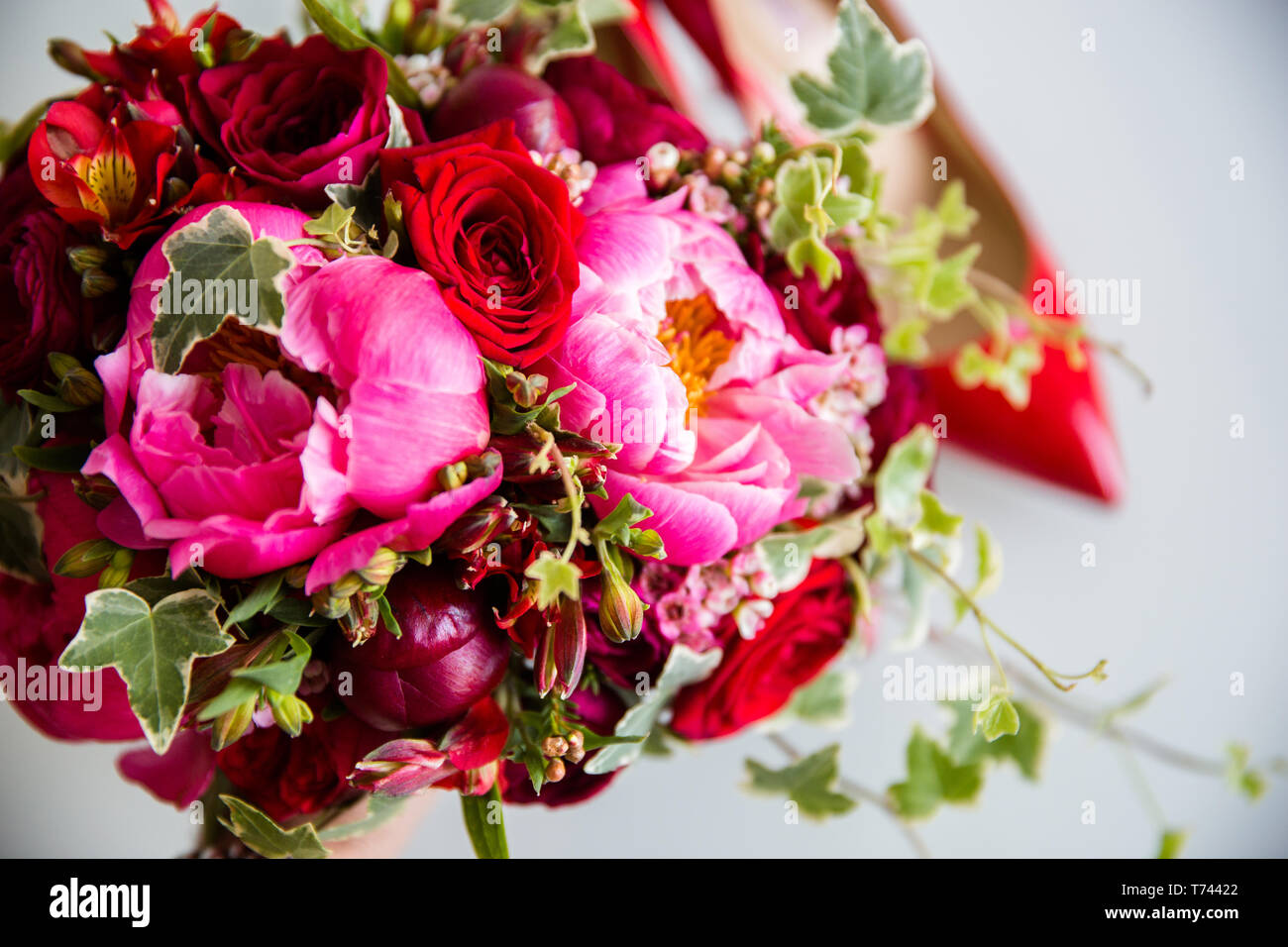 Red roses with pink peonies in the bridal bouquet Stock Photo - Alamy