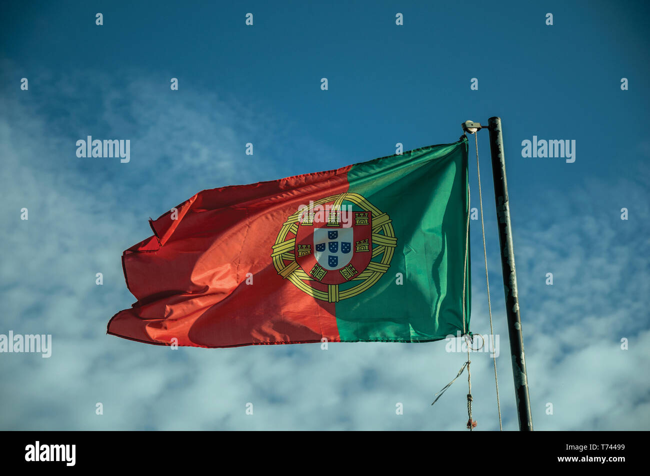 Portuguese flag at sunset fluttering in the wind with blue sky on the ...