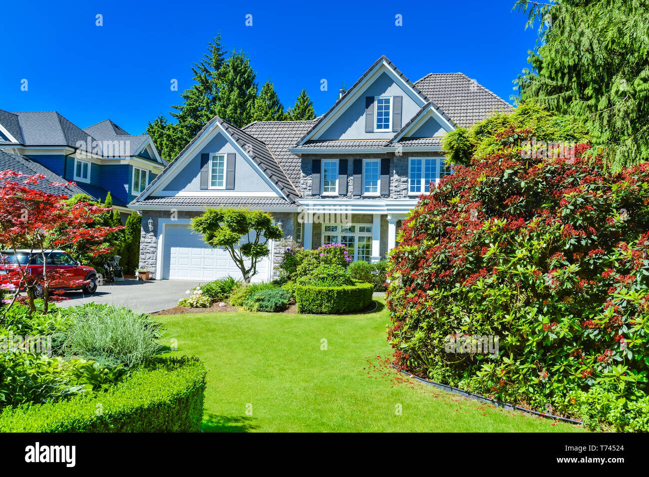 Luxury suburban house with double garage and car parked on concrete ...