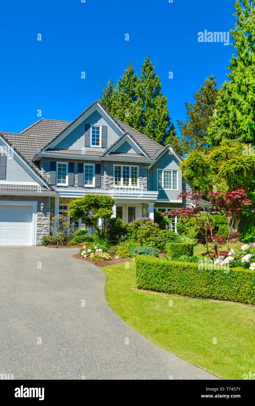 Luxury suburban house with double garage and car parked on concrete ...