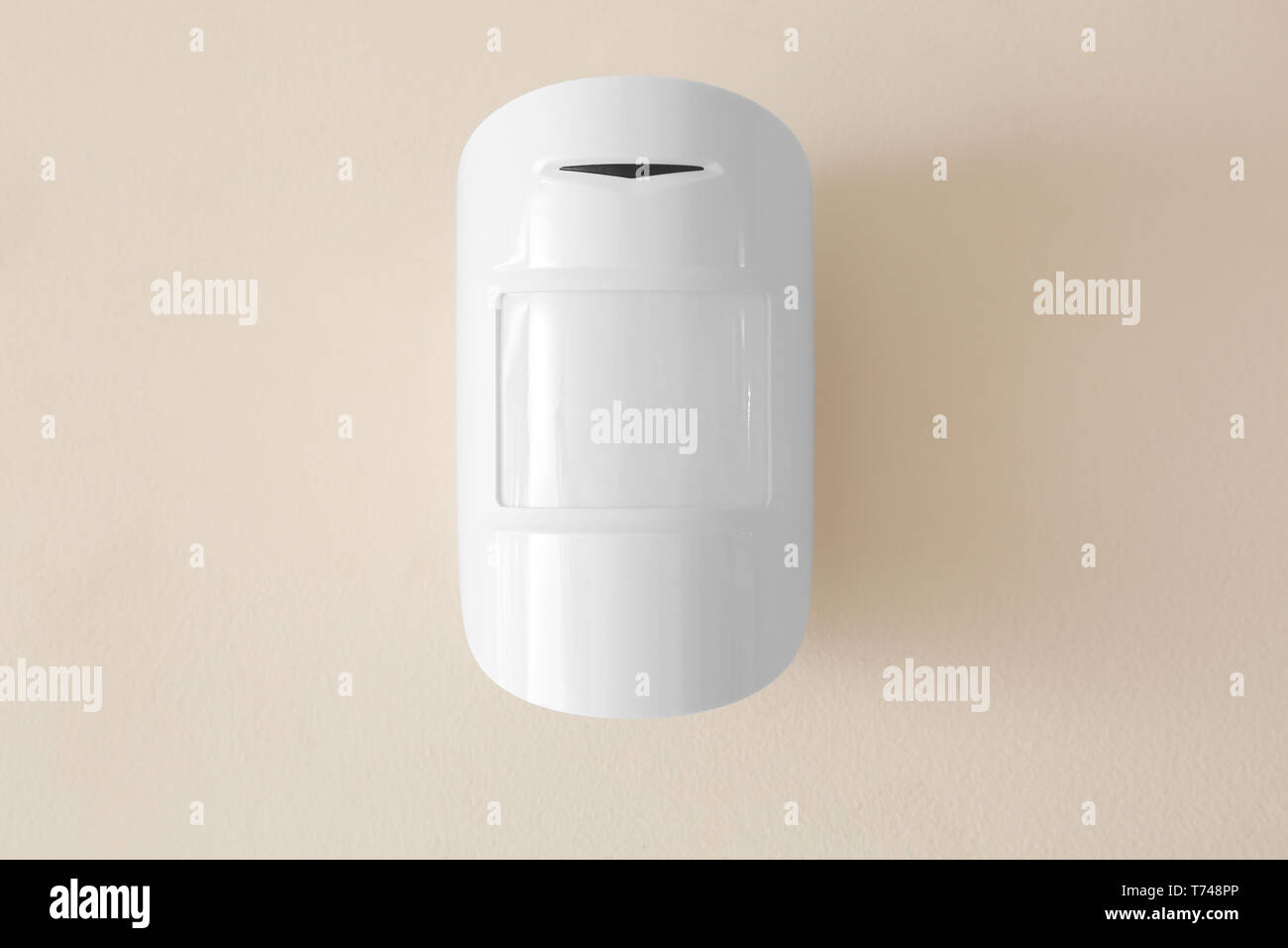 Modern motion sensor on wall indoors Stock Photo - Alamy