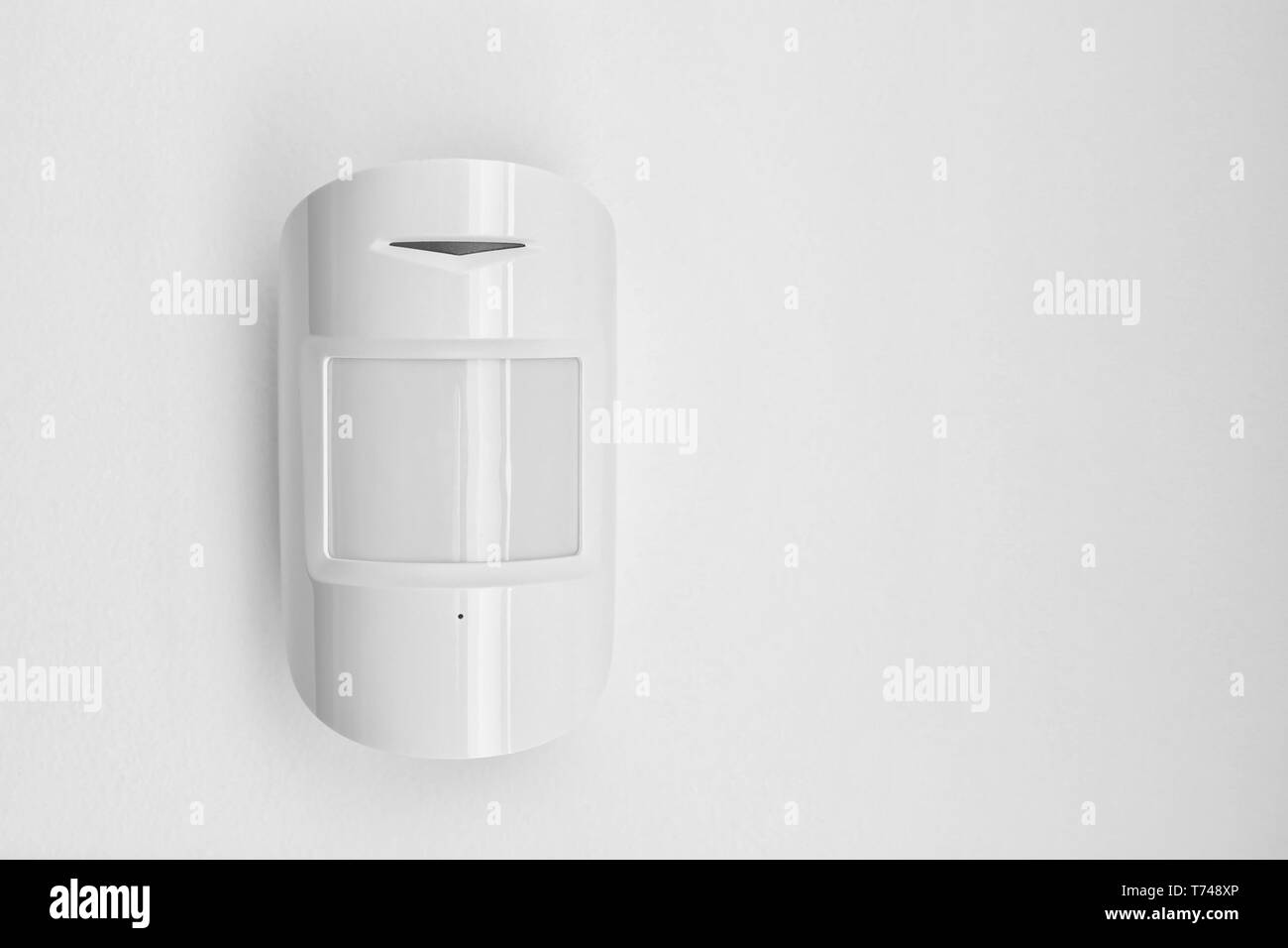 Modern motion sensor indoors Stock Photo - Alamy