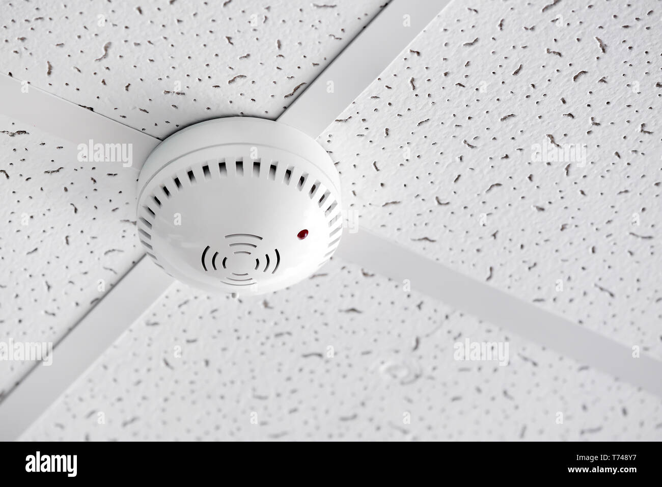 Modern smoke detector on ceiling indoors Stock Photo - Alamy
