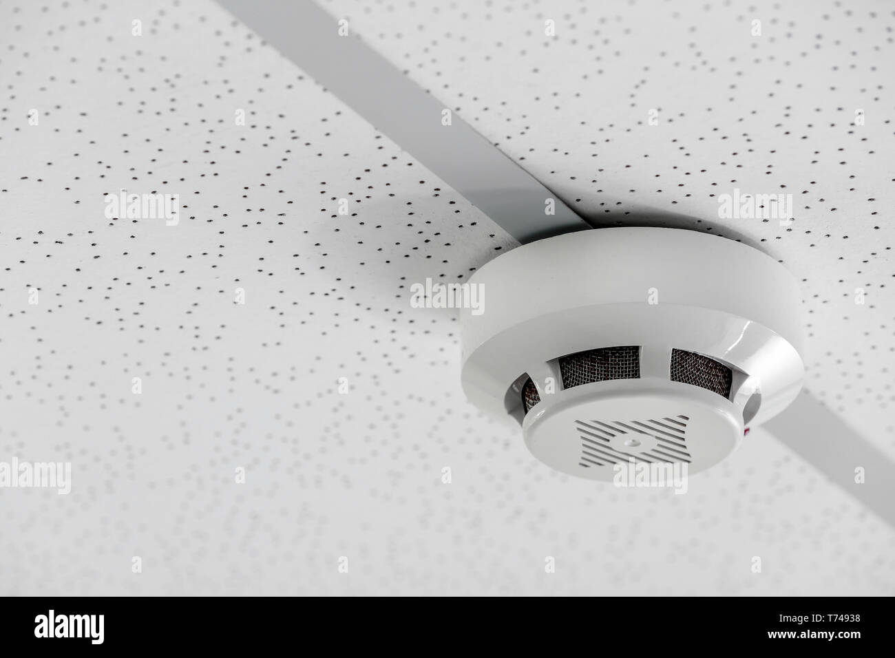 Modern smoke detector on ceiling indoors Stock Photo - Alamy