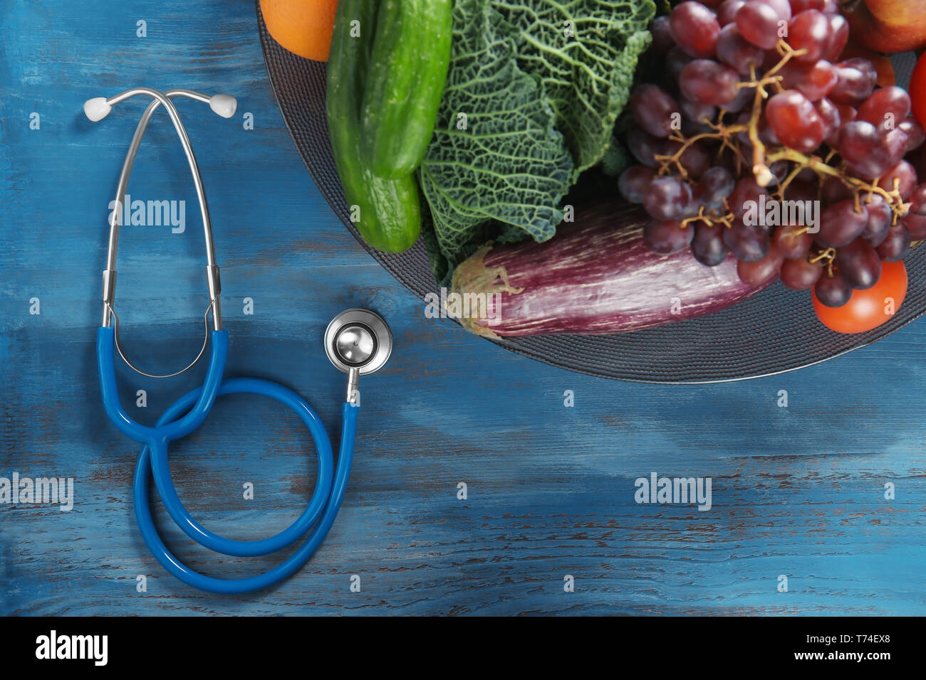 Various fruits and vegetables with stethoscope on wooden table. Healthy ...