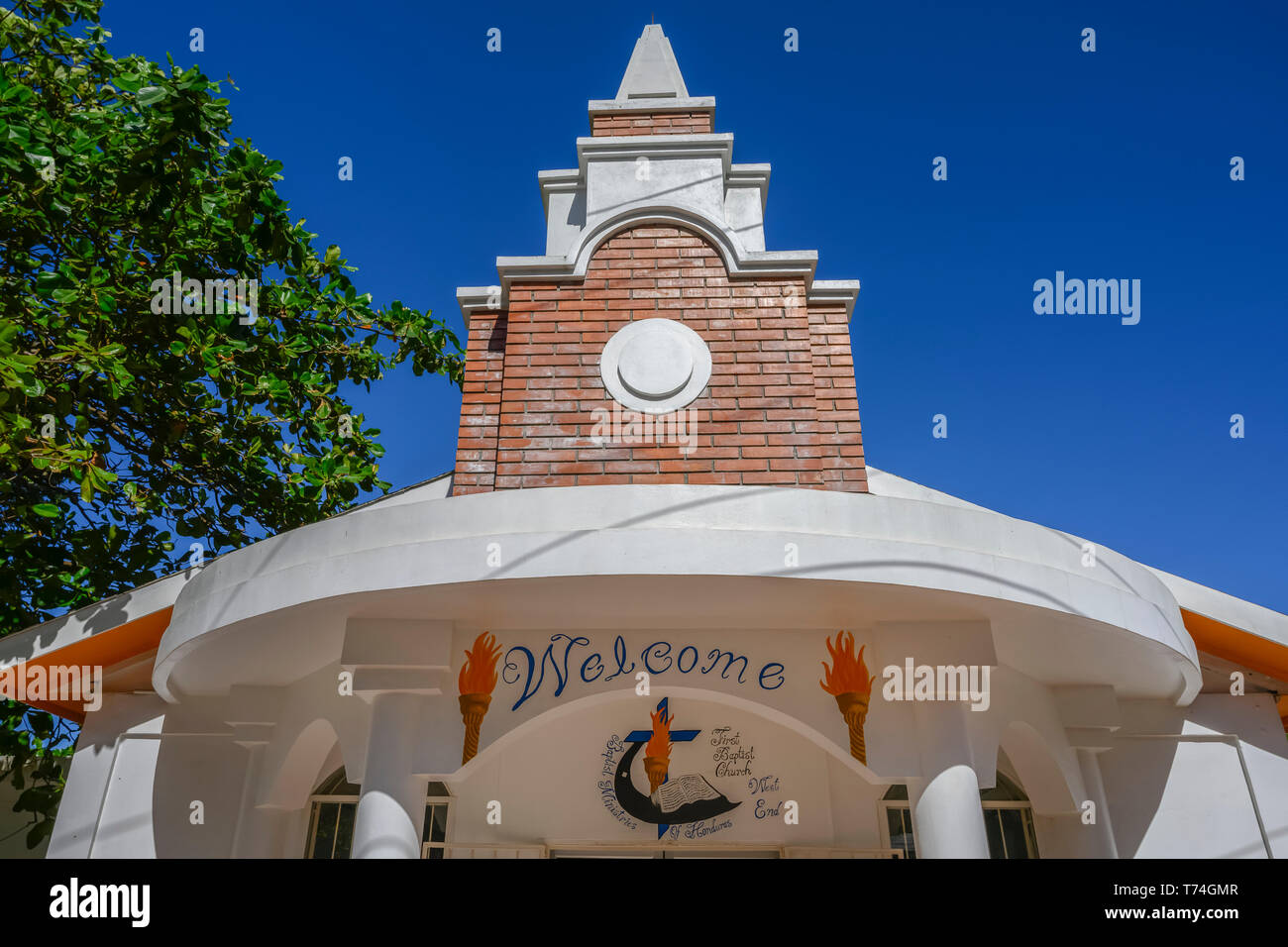 Welcome sign and building against a blue sky, West End Village of ...
