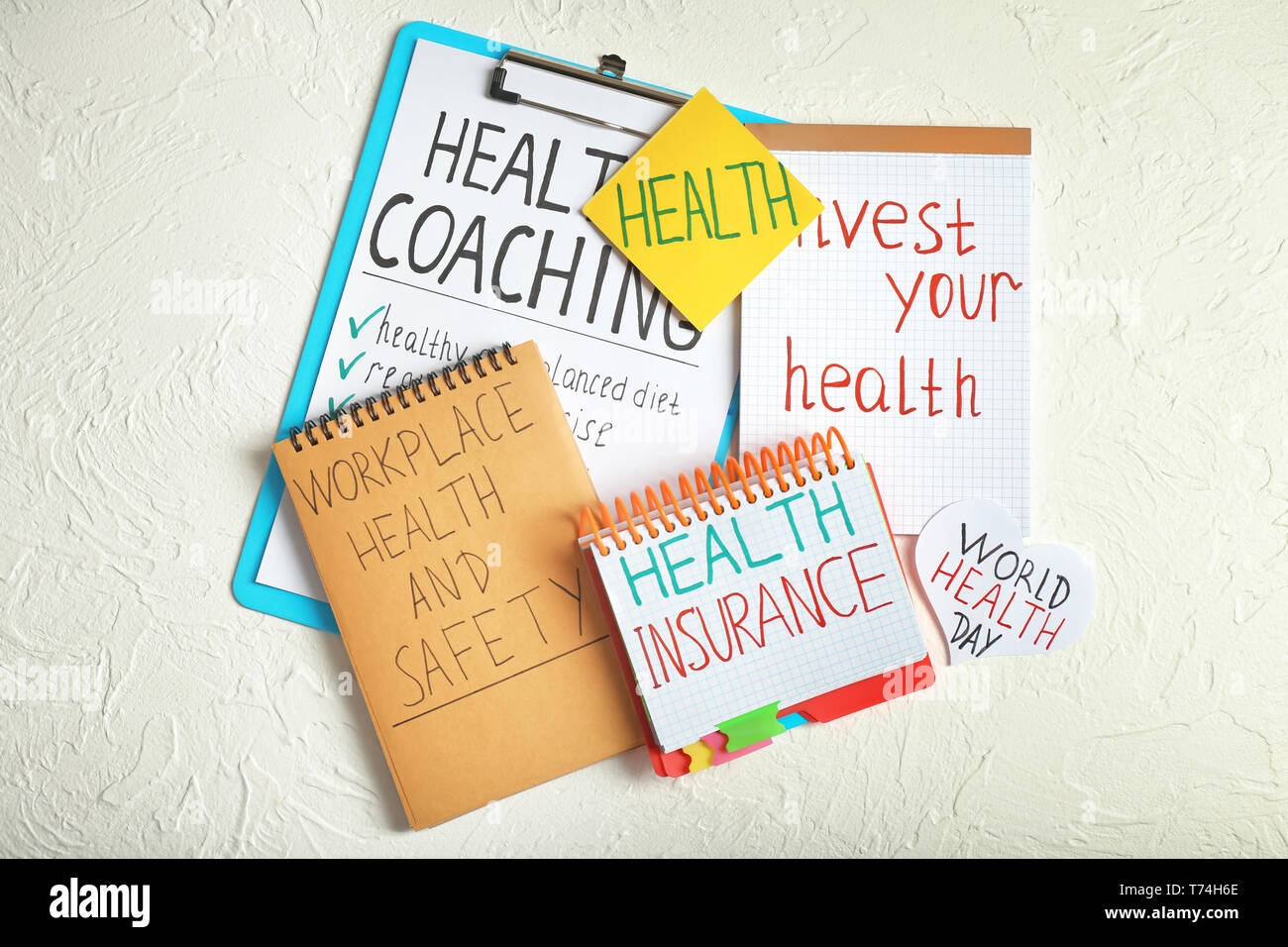 Inscriptions about health written in notebooks on white textured ...