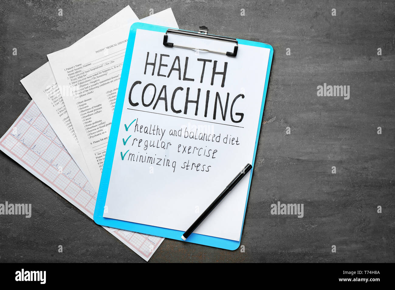 Health coaching written on sheet of paper with medical documents on ...
