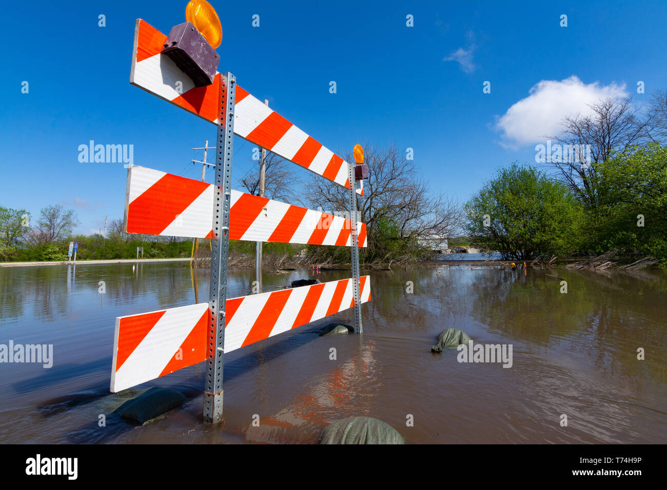 Partially submerged "Road closed" barriers blocking traffic in Utica ...