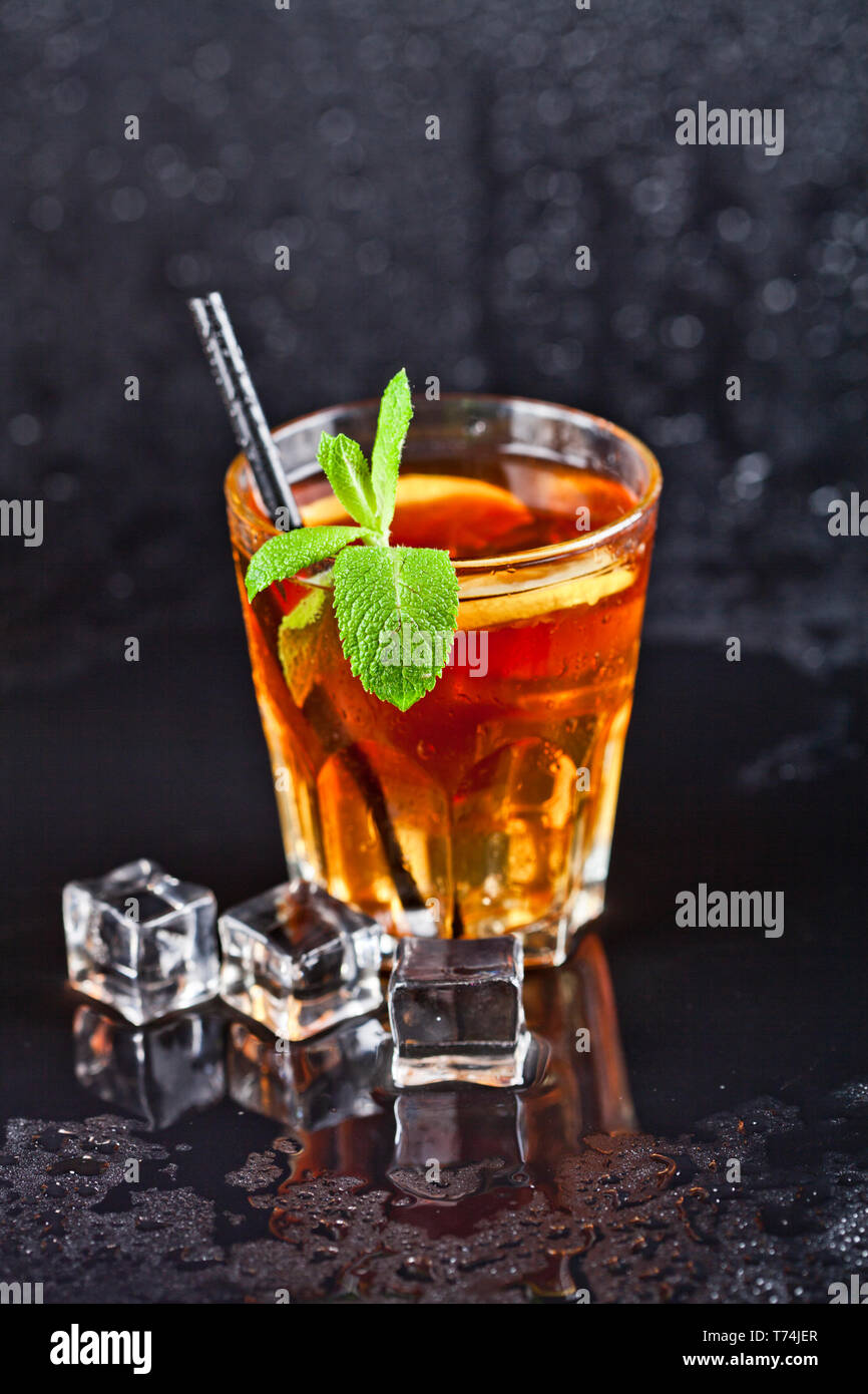 Traditional fresh iced tea with lemon, mint leaves and ice cubes in ...