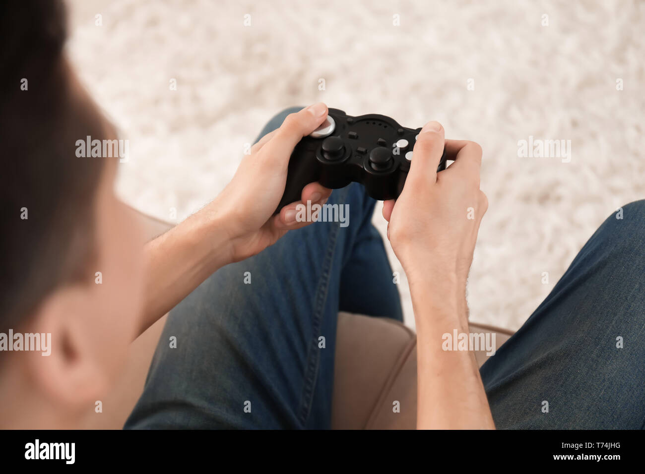 Young man playing video game at home Stock Photo - Alamy